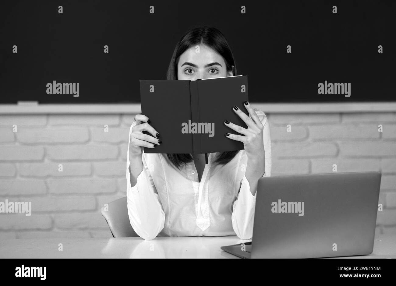 Student preparing exam and learning lessons in school classroom. Female ...