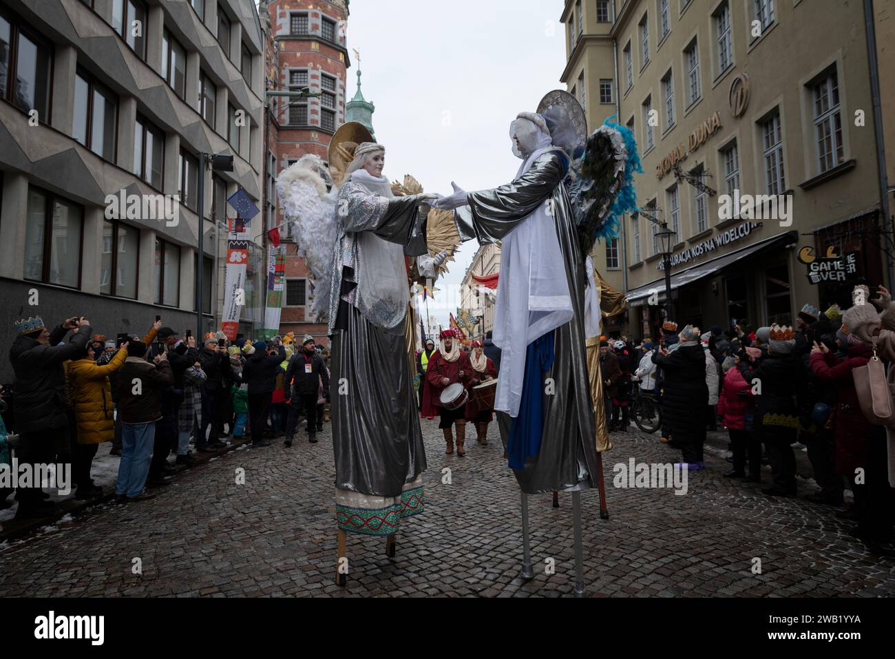 Figures of angels on stilts take part in the Procession of the Three ...