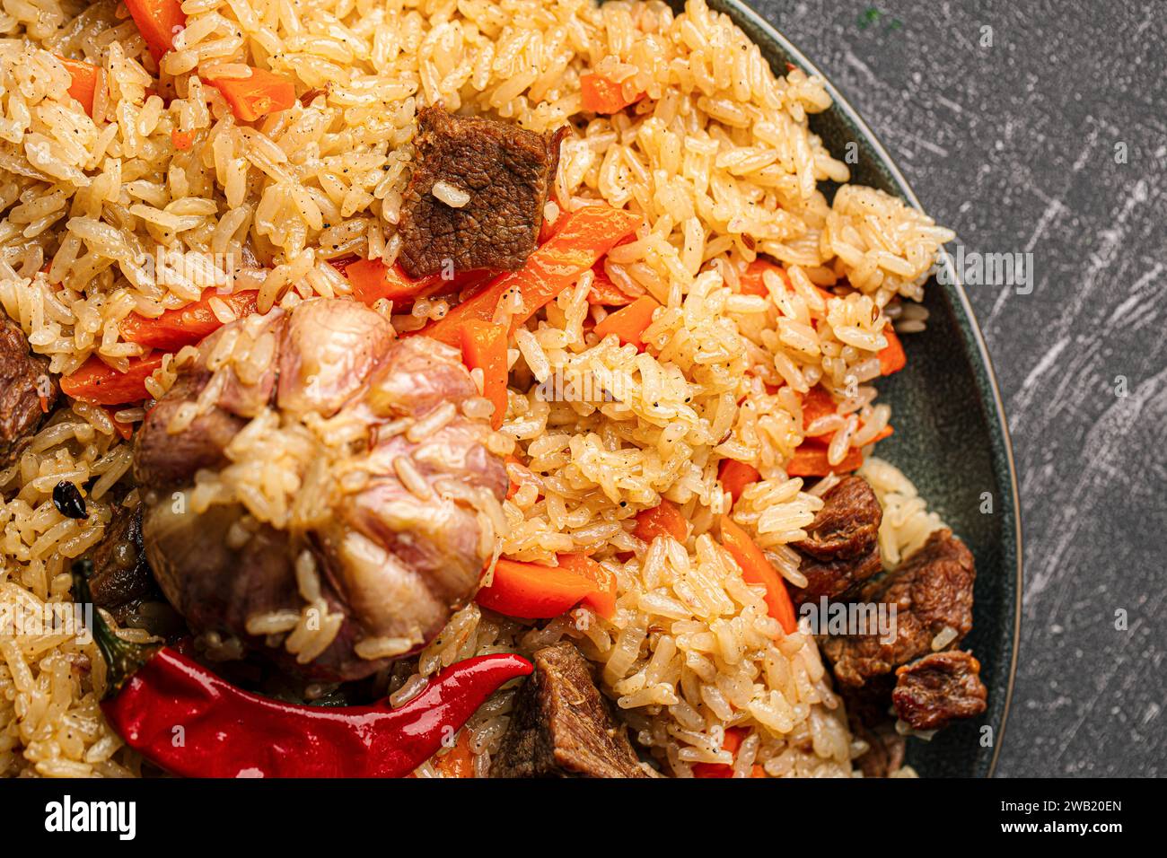Large dish with Uzbek festive pilaf plov Stock Photo - Alamy