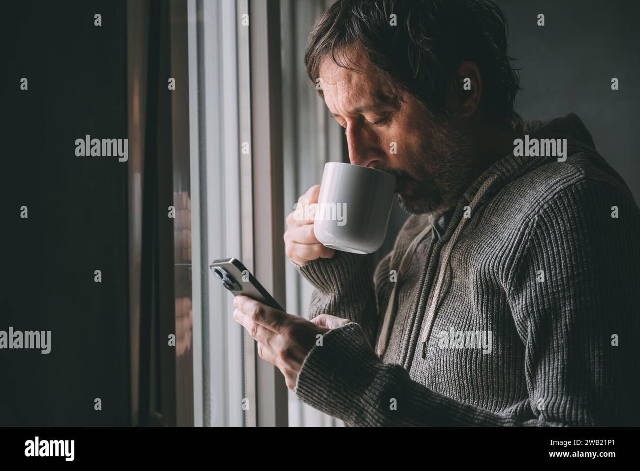 Morning coffee break, adult caucasian unkempt man drinking coffee from ...