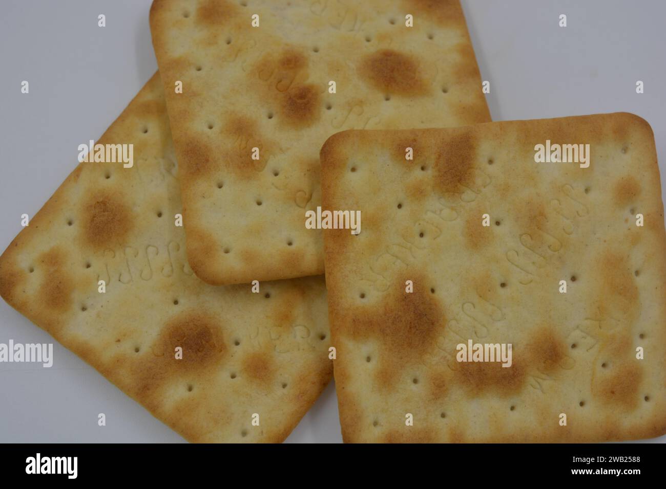 Branded, factory-made biscuits, large thin salted crackers are arranged ...