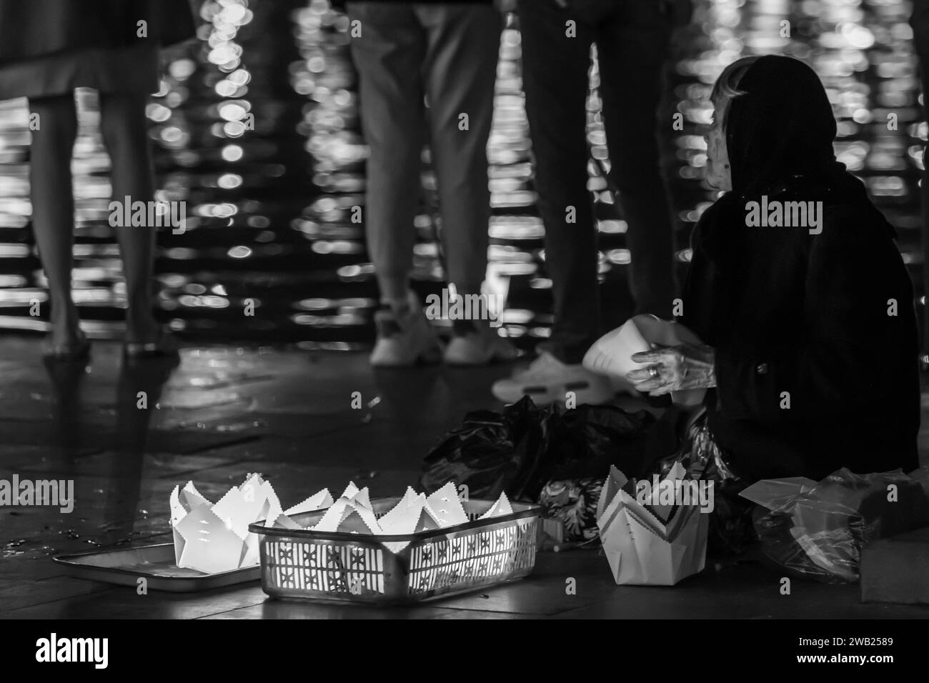 Old poor woman is selling lantern and candles in Hoi An Vietnam Stock ...