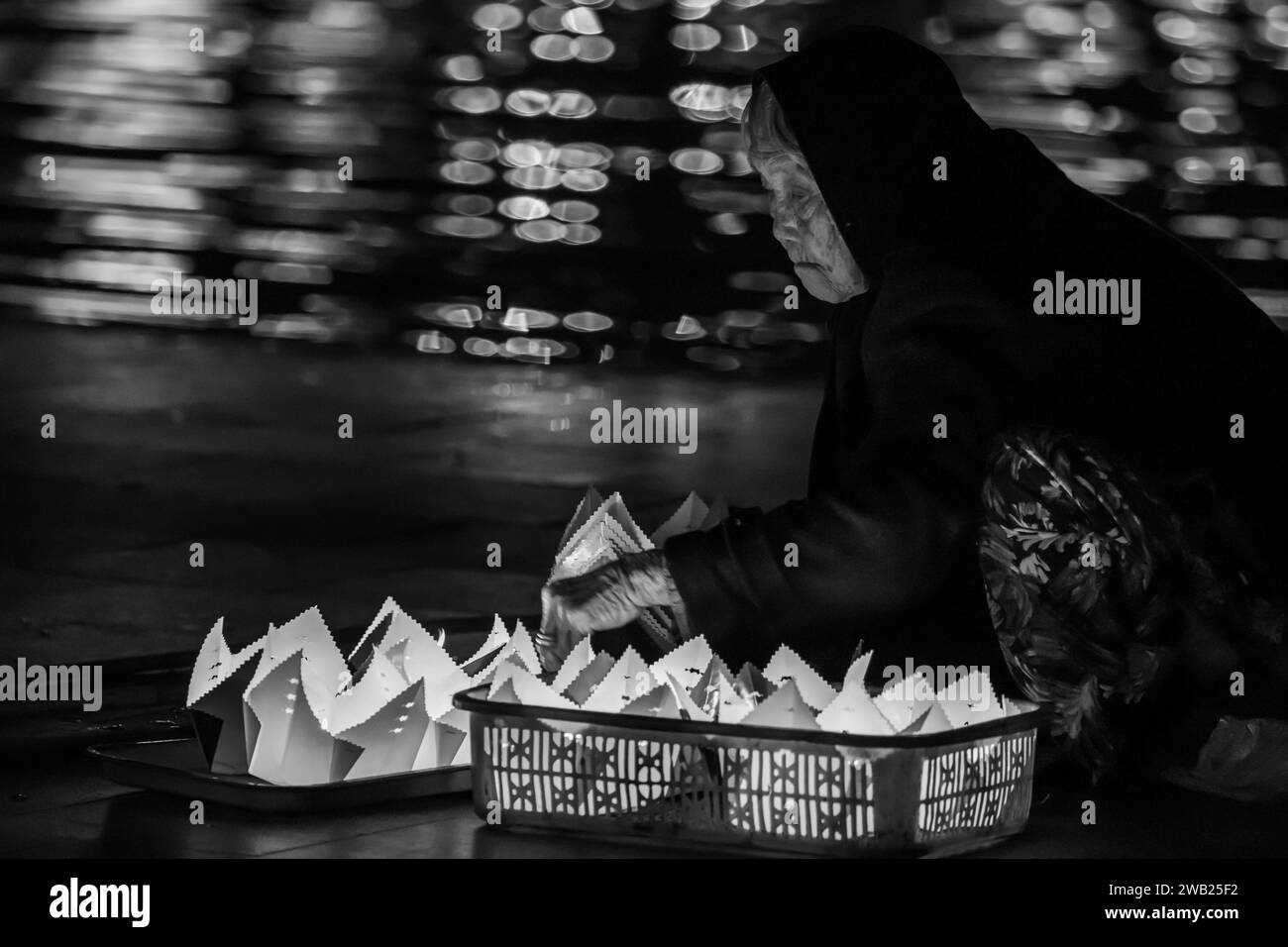 Old poor woman is selling lantern and candles in Hoi An Vietnam Stock ...