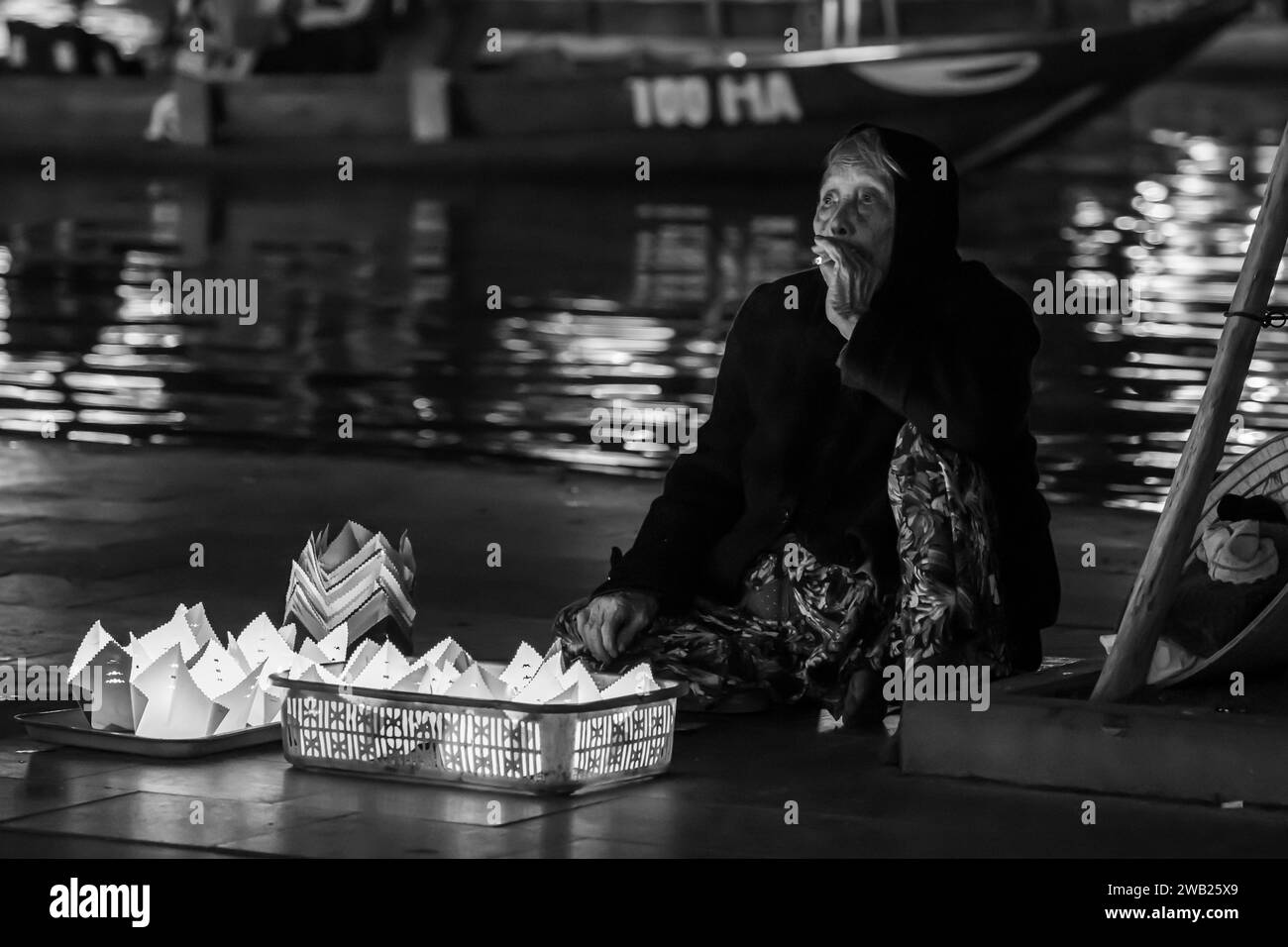 Old poor woman is selling lantern and candles in Hoi An Vietnam Stock ...