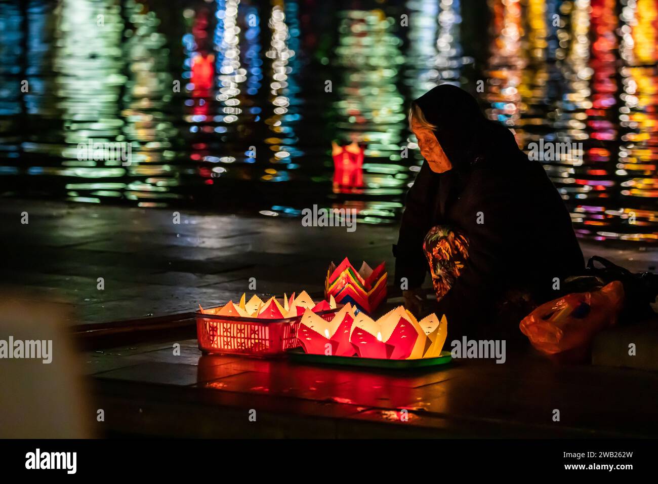Old poor woman is selling lantern and candles in Hoi An Vietnam Stock ...