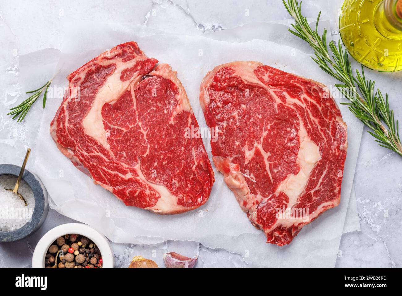 Raw ribeye steaks with savory spices. Flat lay Stock Photo - Alamy
