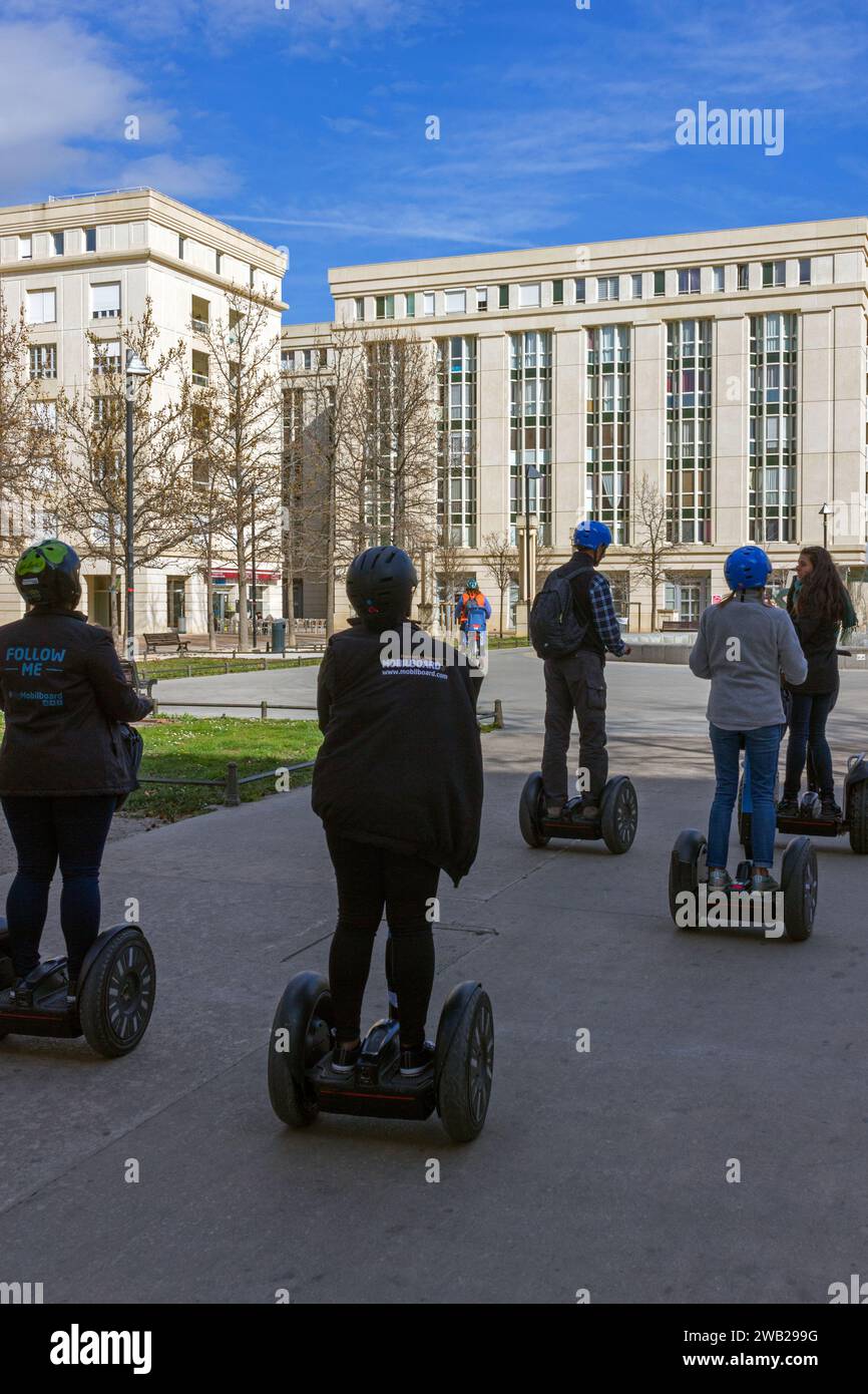Group of tourists visiting the city on Segways. Montpellier, Occitanie ...