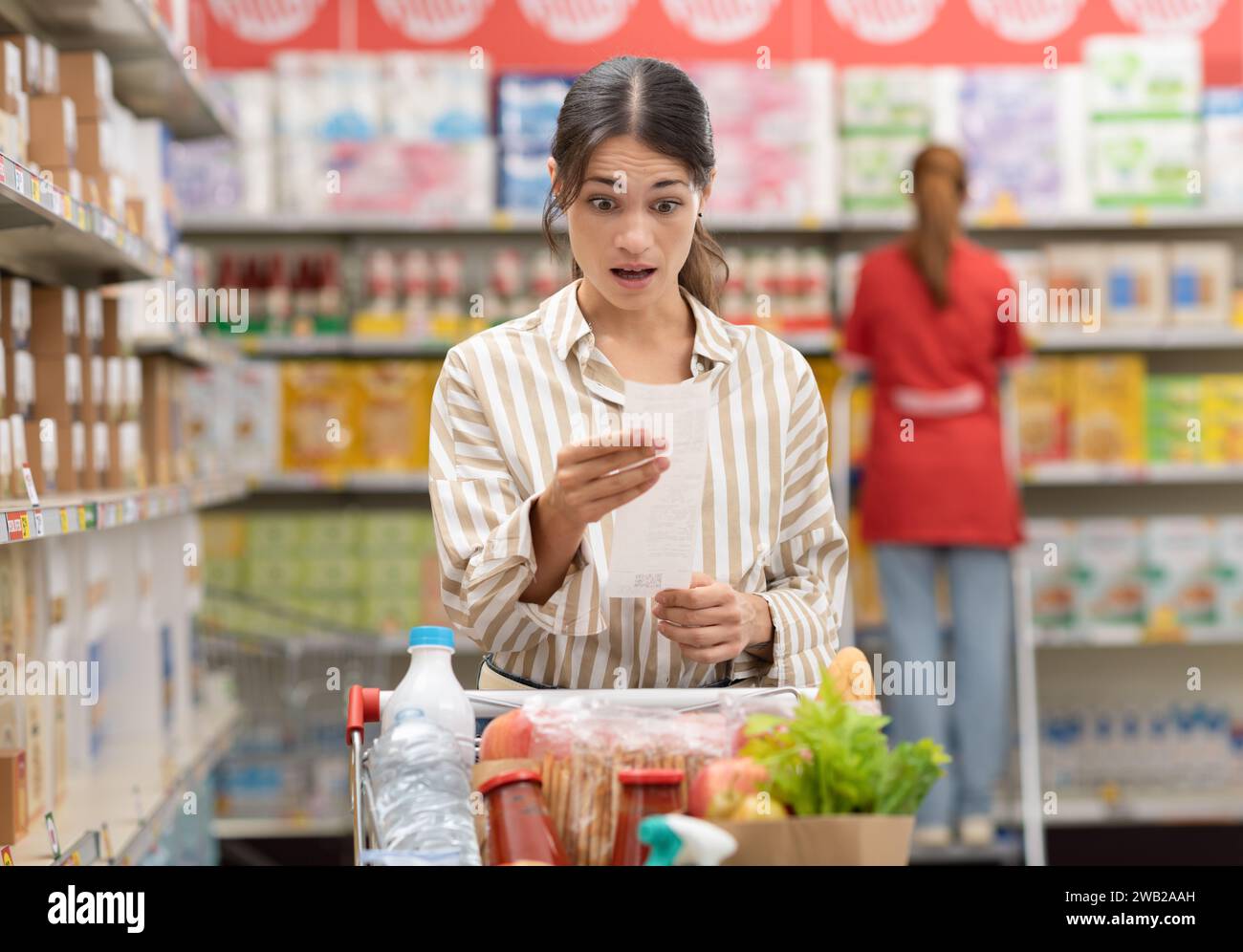Shocked angry customer checking an expensive long grocery receipt at ...