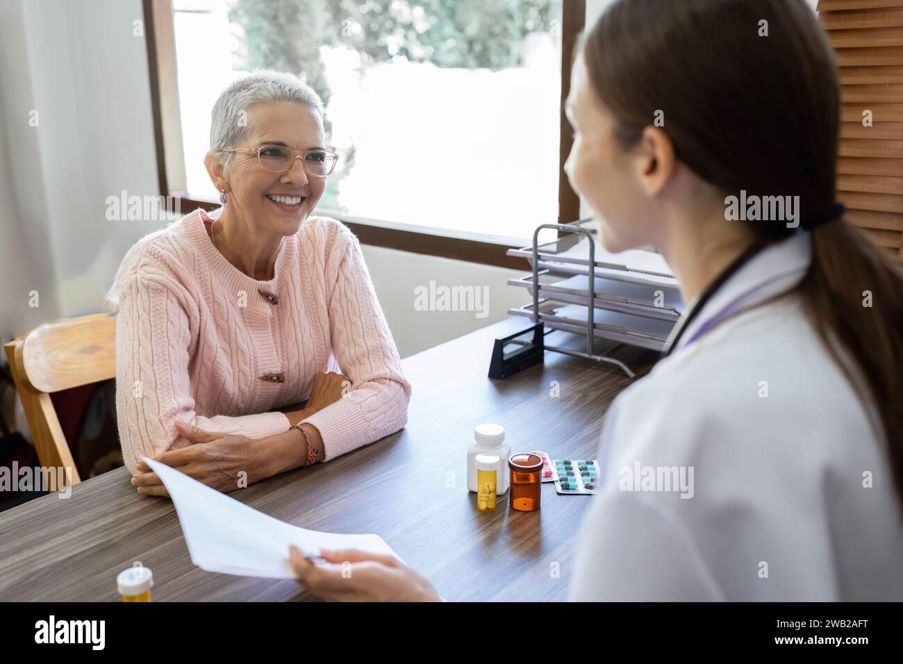 Female doctor are advise medication and vitamin daily to elderly ...