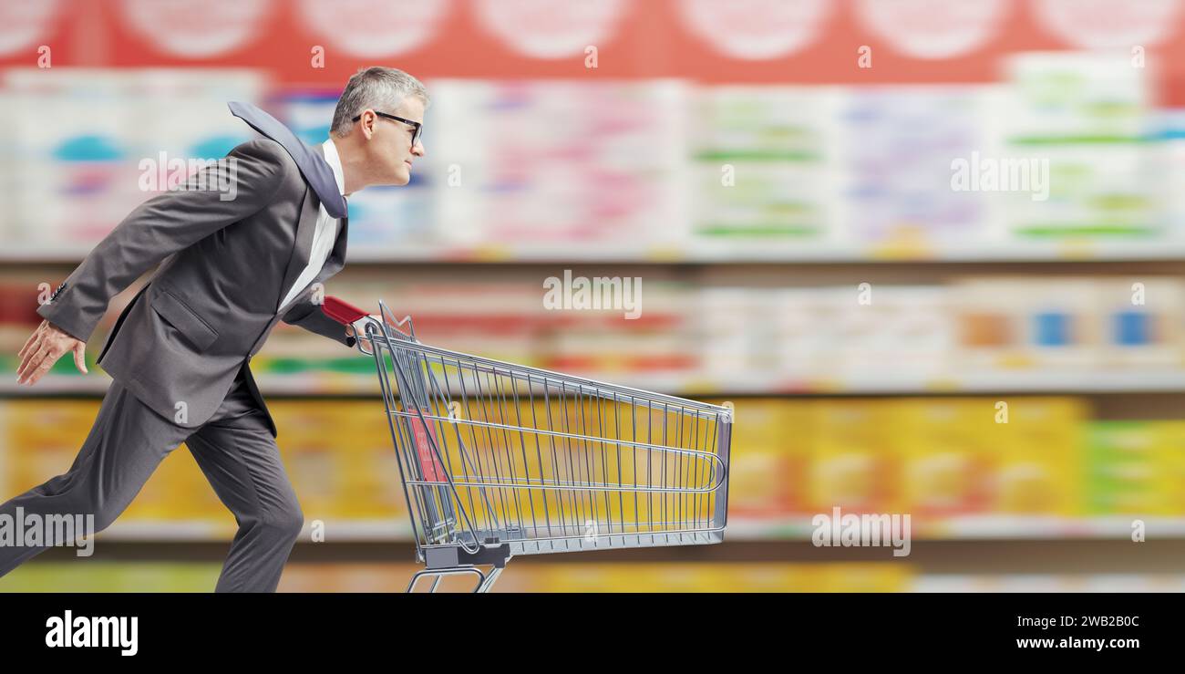 Fast businessman running and pushing a supermarket shopping cart Stock ...