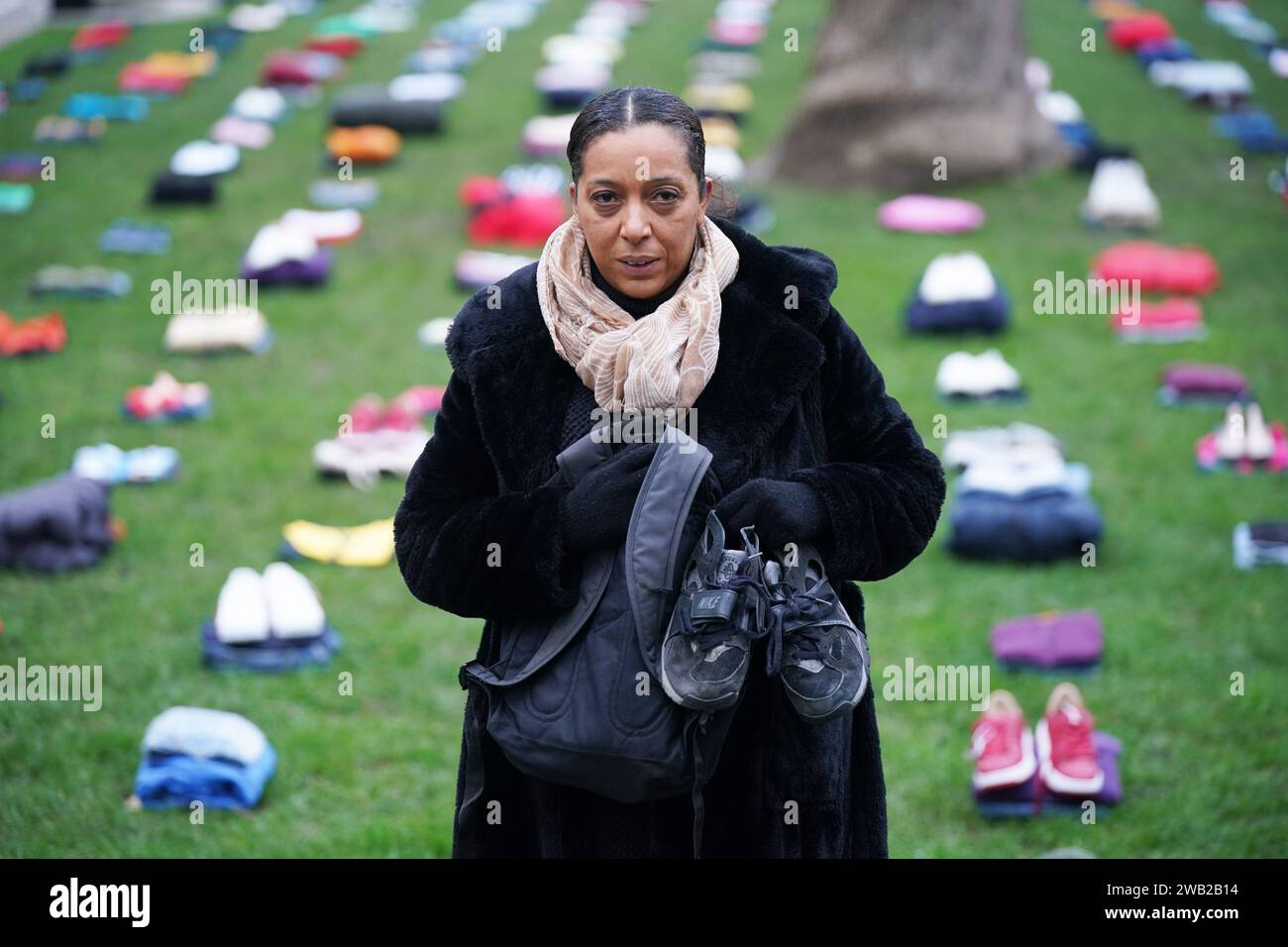 Yemi Hughes, holding clothes her son Andre Aderemi, 19, was wearing ...