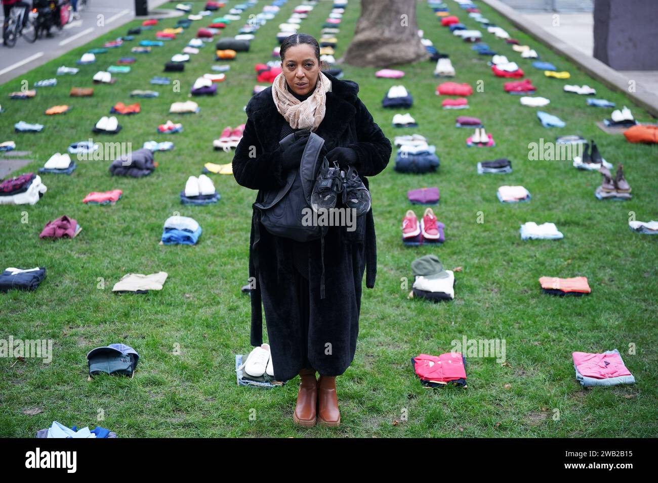Yemi Hughes, holding clothes her son Andre Aderemi, 19, was wearing ...
