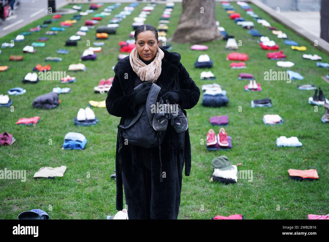 Yemi Hughes, holding clothes her son Andre Aderemi, 19, was wearing ...