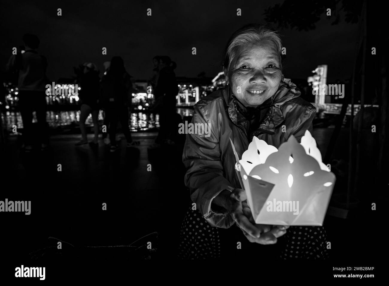 Old poor woman is selling lantern and candles in Hoi An Vietnam Stock ...