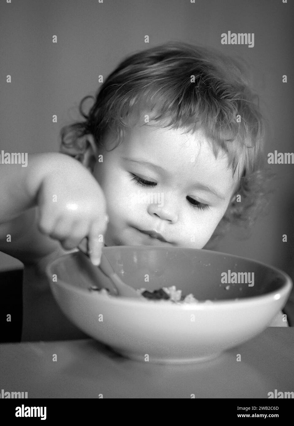Kid eats breakfast kitchen Black and White Stock Photos & Images - Alamy