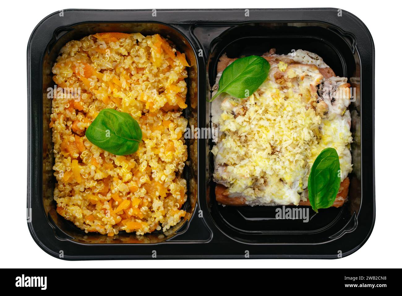 baked fish with sauce, side dish of bulgur and vegetables in lun Stock ...