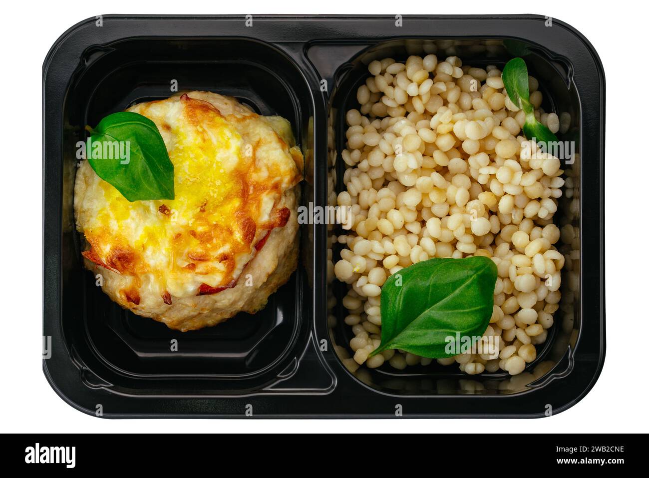 baked fish with sauce and side dish in lunch box on white backgr Stock ...