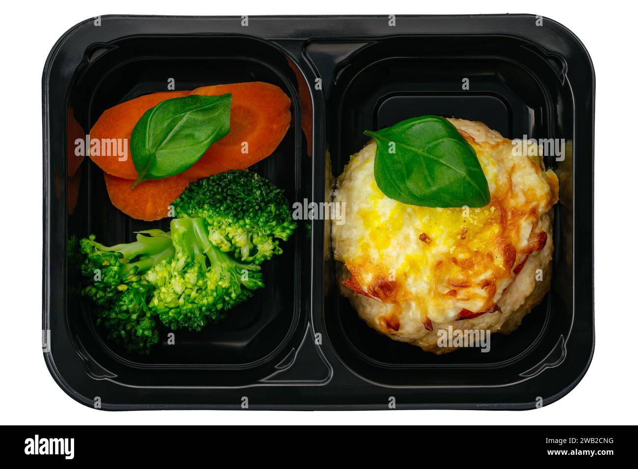 baked fish with sauce and side dish in lunch box on white backgr Stock ...
