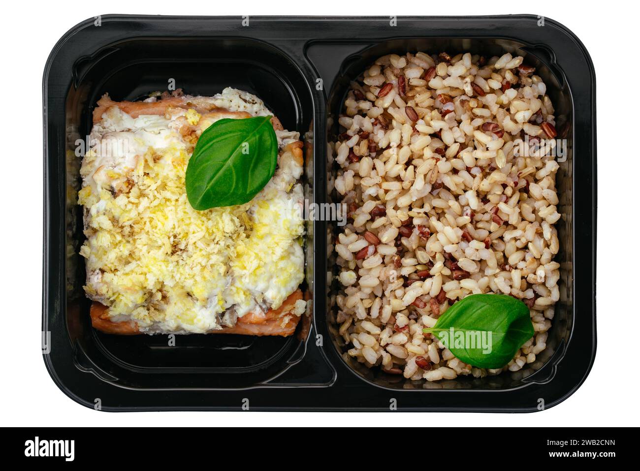 baked fish with sauce and side dish in lunch box on white backgr Stock ...