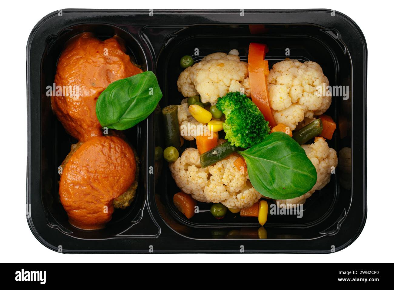 meatballs in sauce with vegetable side dish in lunch box on whit Stock ...