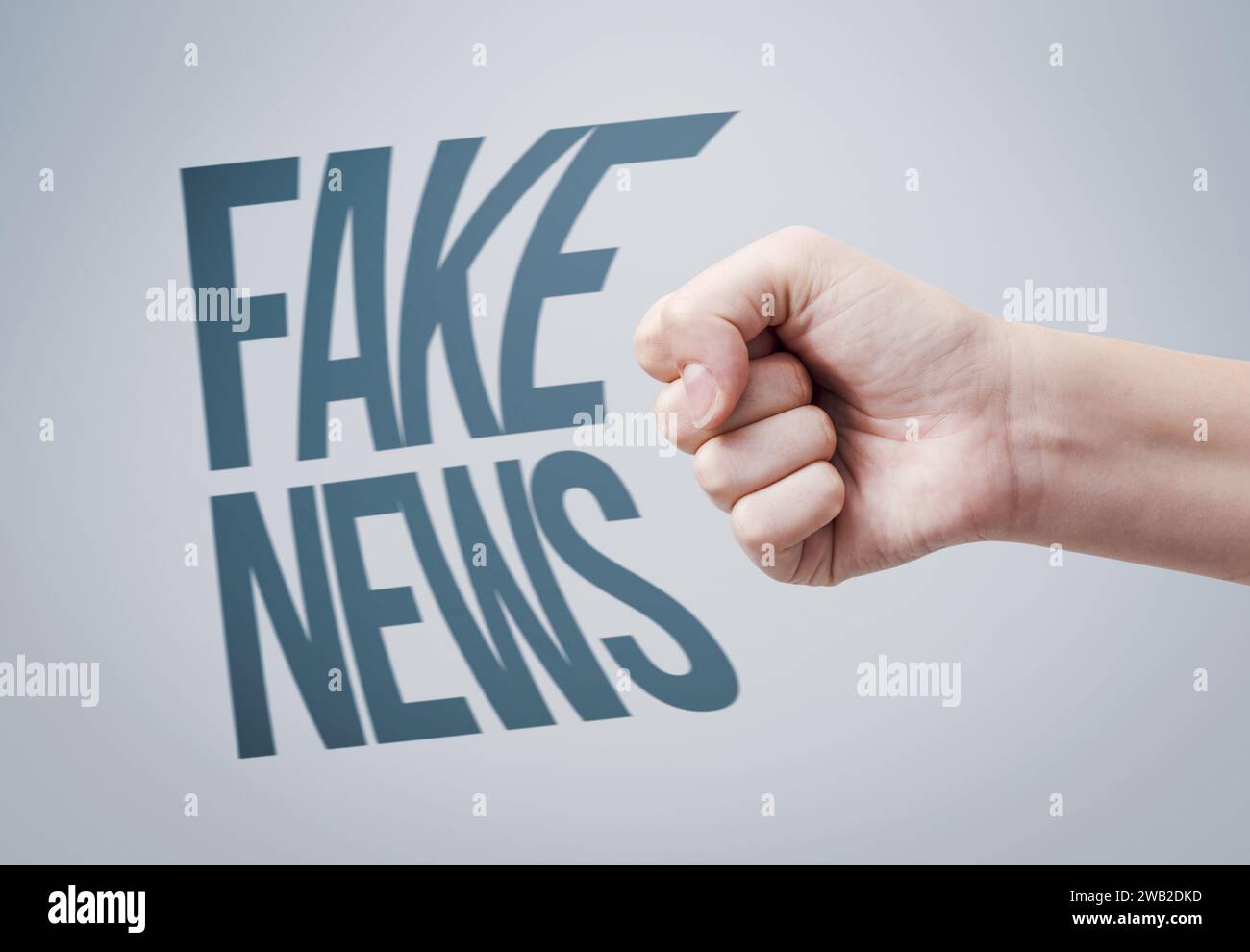 Aggressive fist punching fake news and fighting disinformation Stock ...