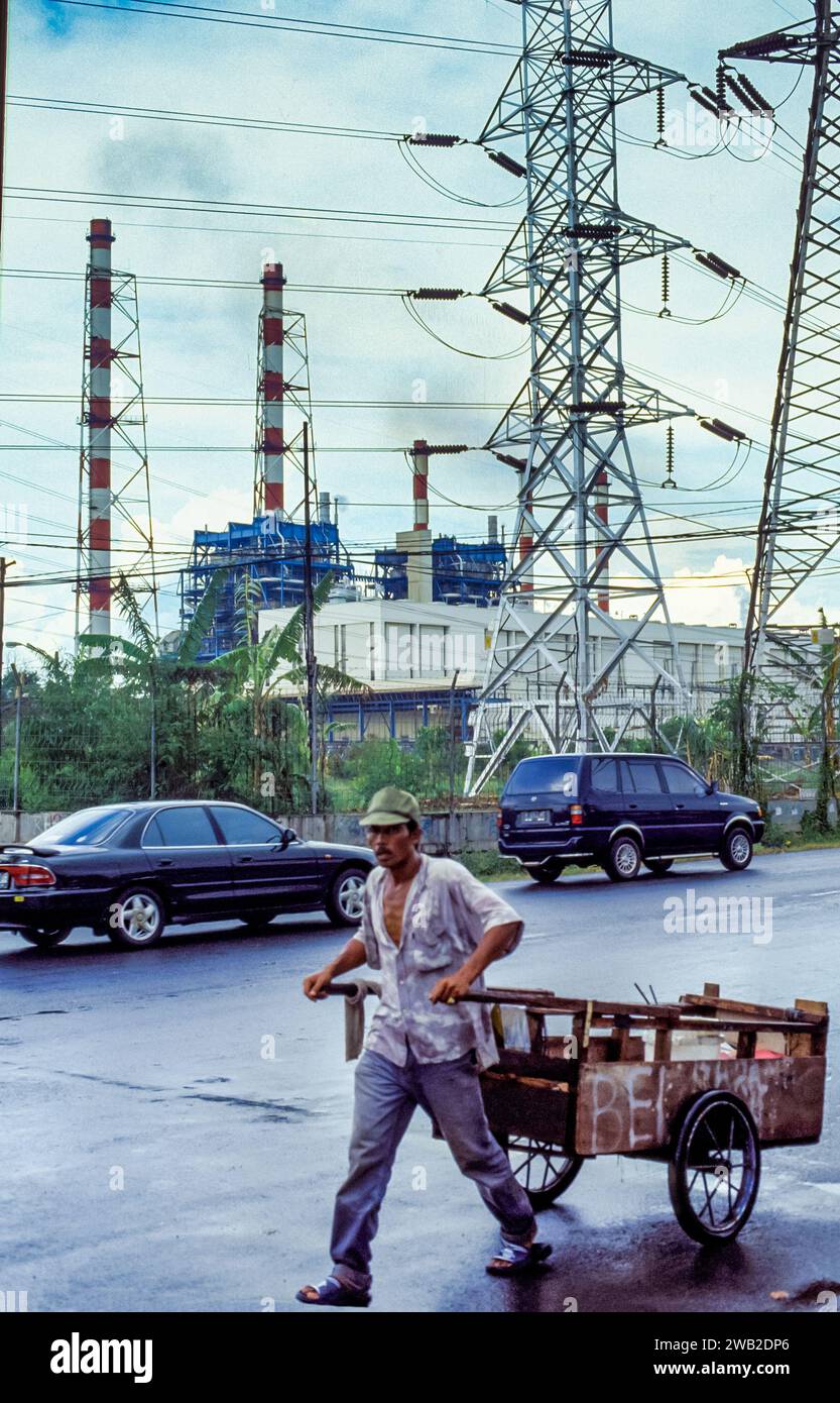 Indonesia, Java - Man with pushcart in front of power station on Java ...