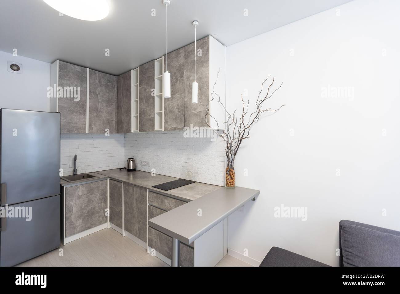 Spacious kitchen with minimalist square shaped furniture, grey floor ...