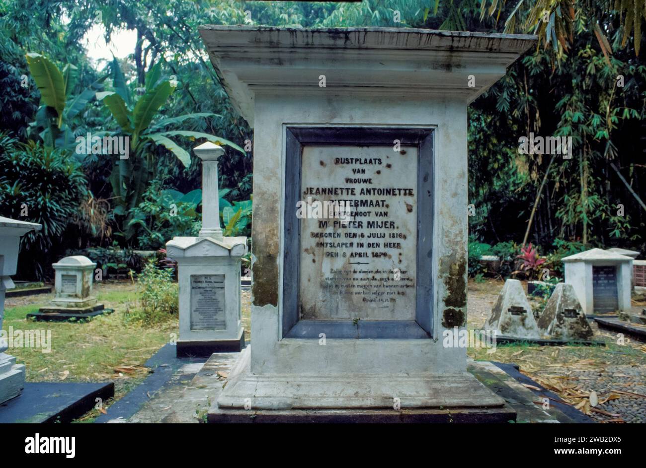 Indonesia, Bogor. Ancient Dutch graveyard with a tombstone of of a ...