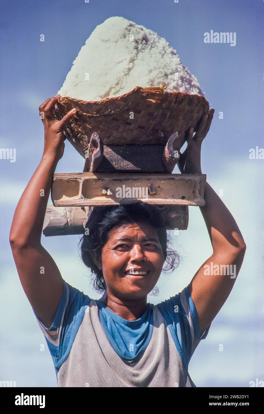 A woman carries water indonesia hi-res stock photography and images - Alamy