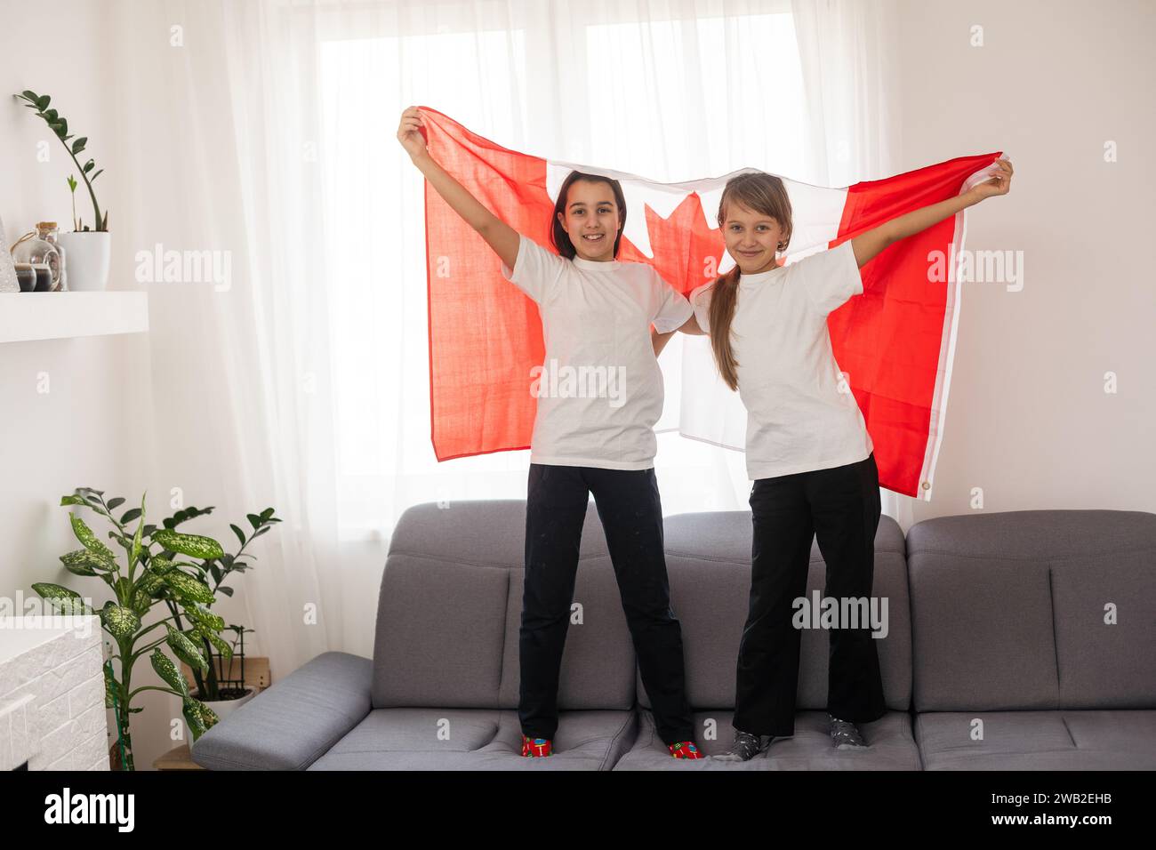 Happy Canada Day Celebration. Two girls with big Canada flag in their ...
