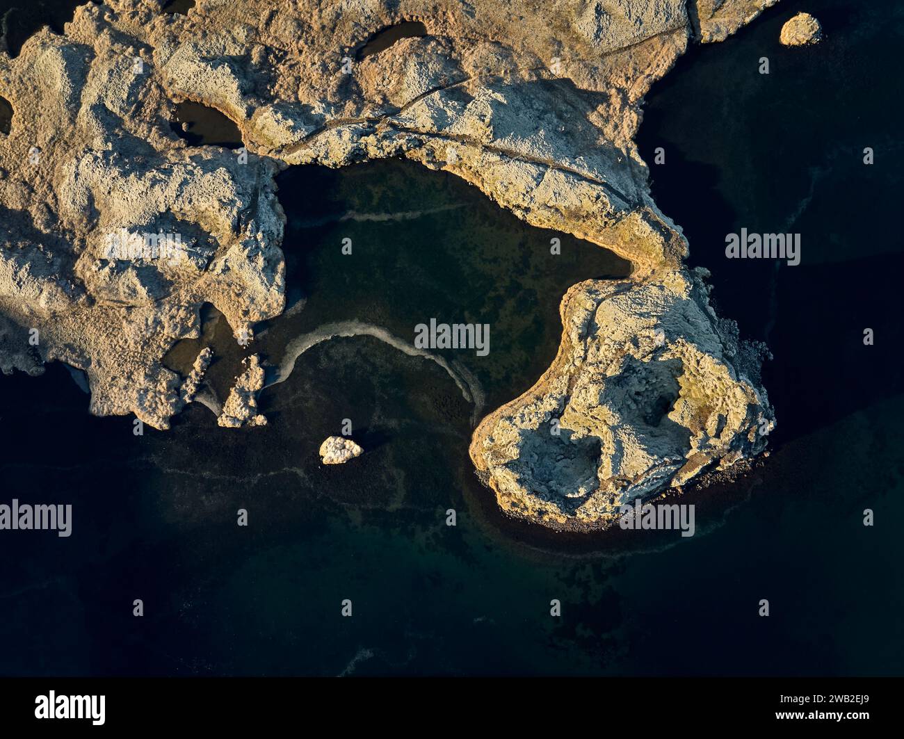 Amazing view of rough rocks and dry land in sea water Stock Photo - Alamy