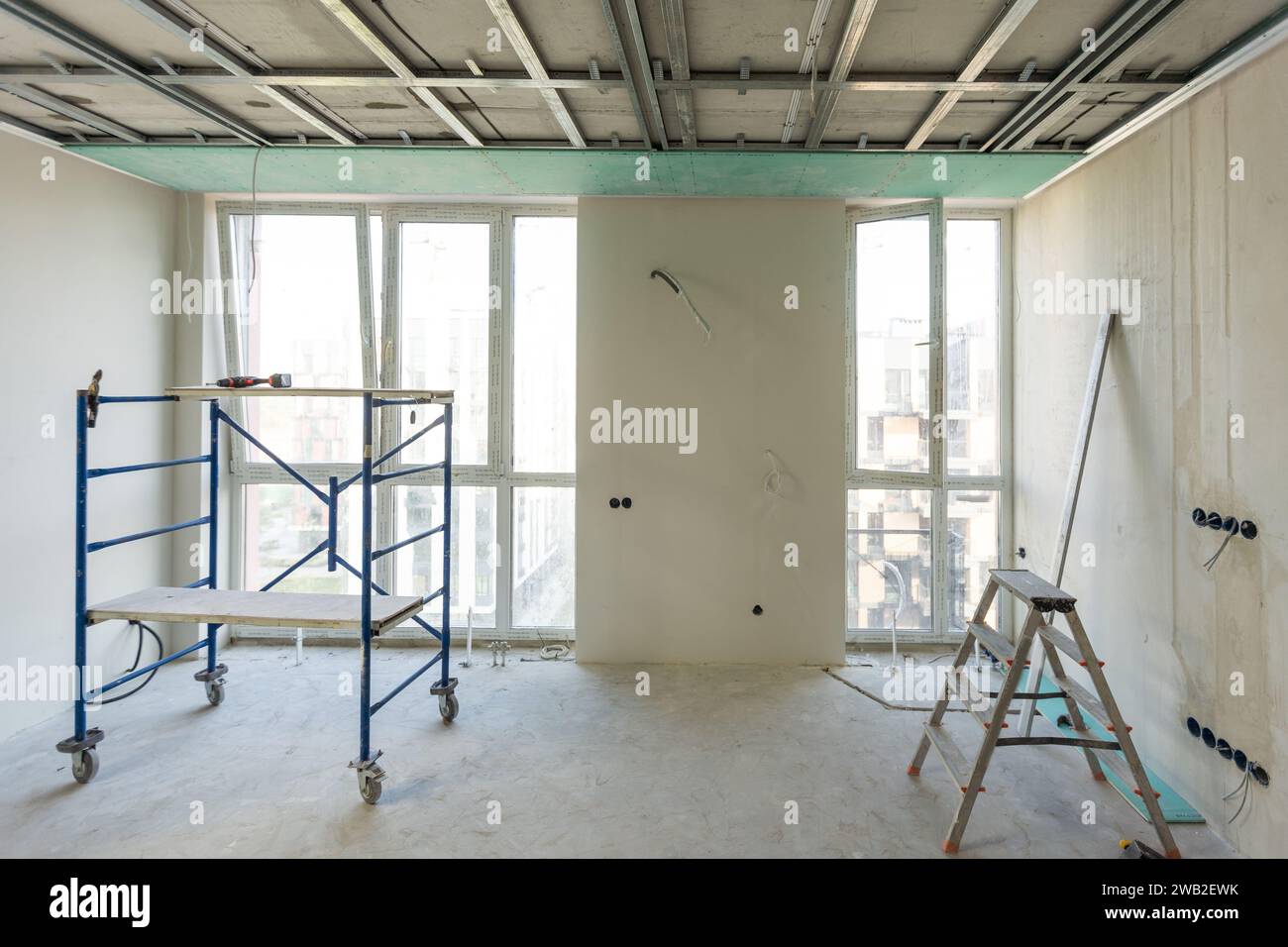 Drywall installation work in progress by construction workers at ...