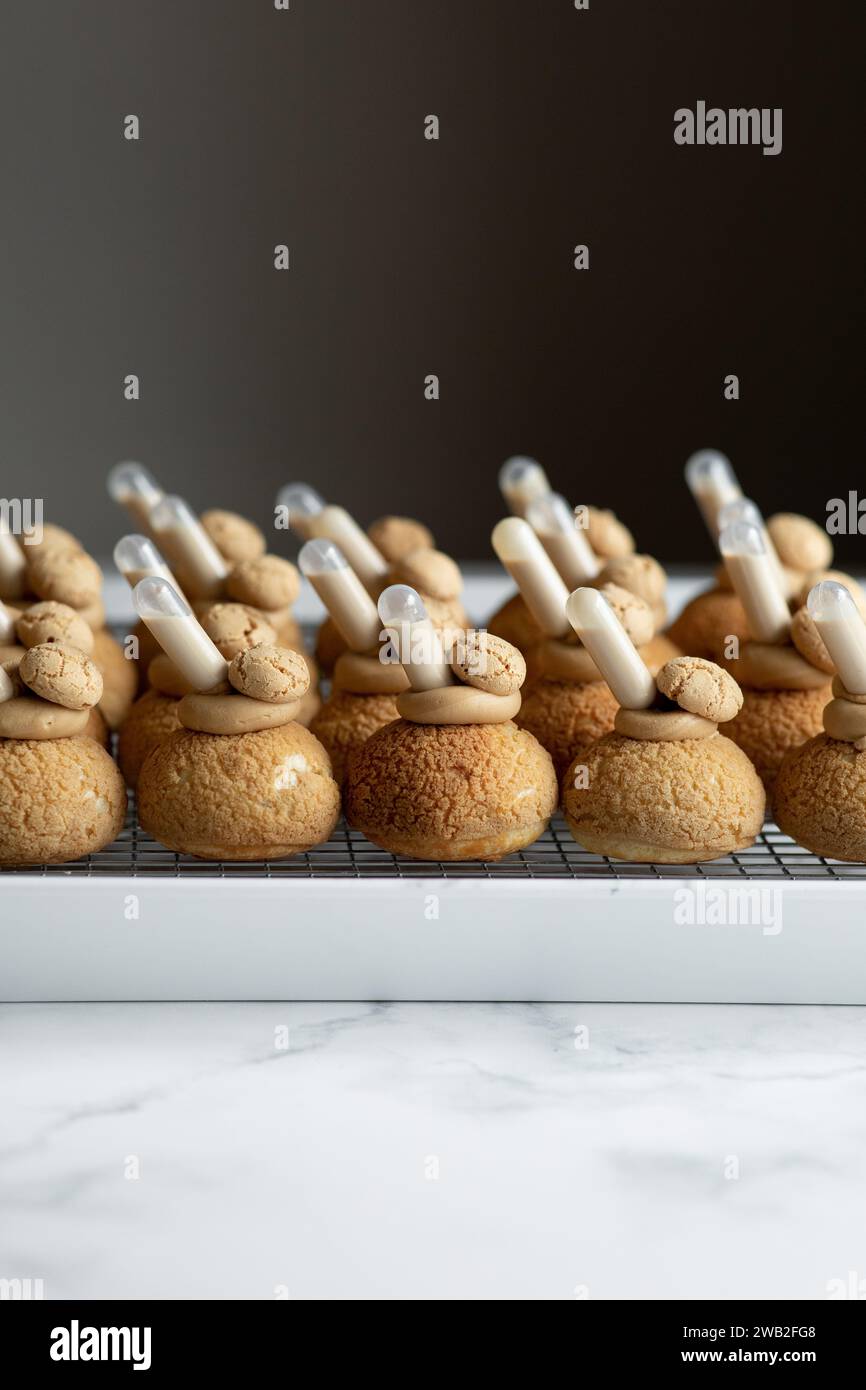 Coffee Eclair Choux with ganache, cookie and a coffee filled cylinder ...