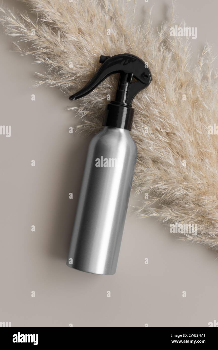 Aluminium cosmetic trigger sprayer bottle mockup with a pampas on the ...
