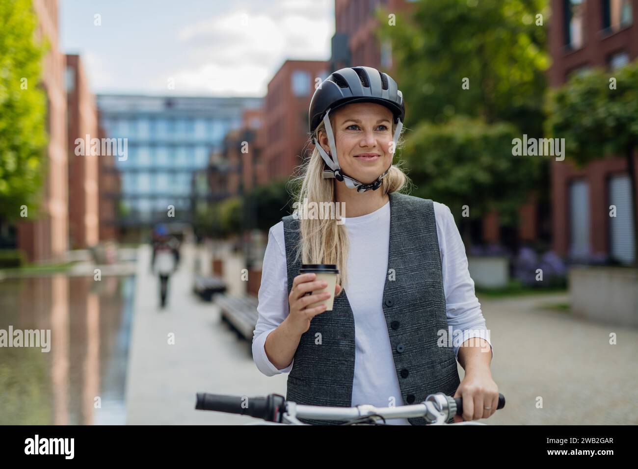 Beautiful middle-aged woman commuting through the city, buying ...