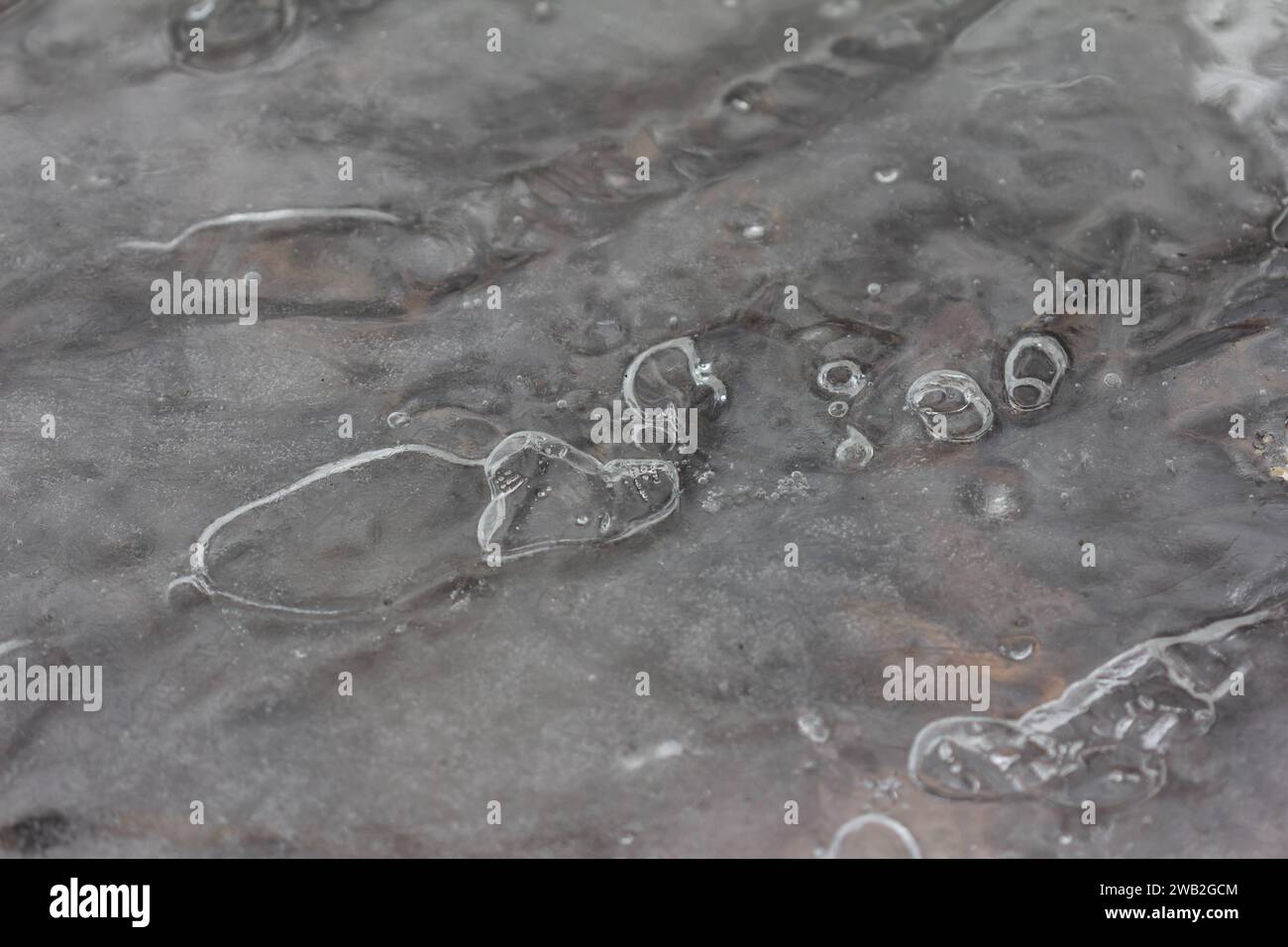 Air bubbles frozen in sheet of ice Stock Photo - Alamy
