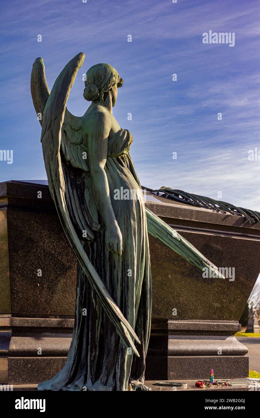 Angel statue grave overlooking cemetery Stock Photo - Alamy