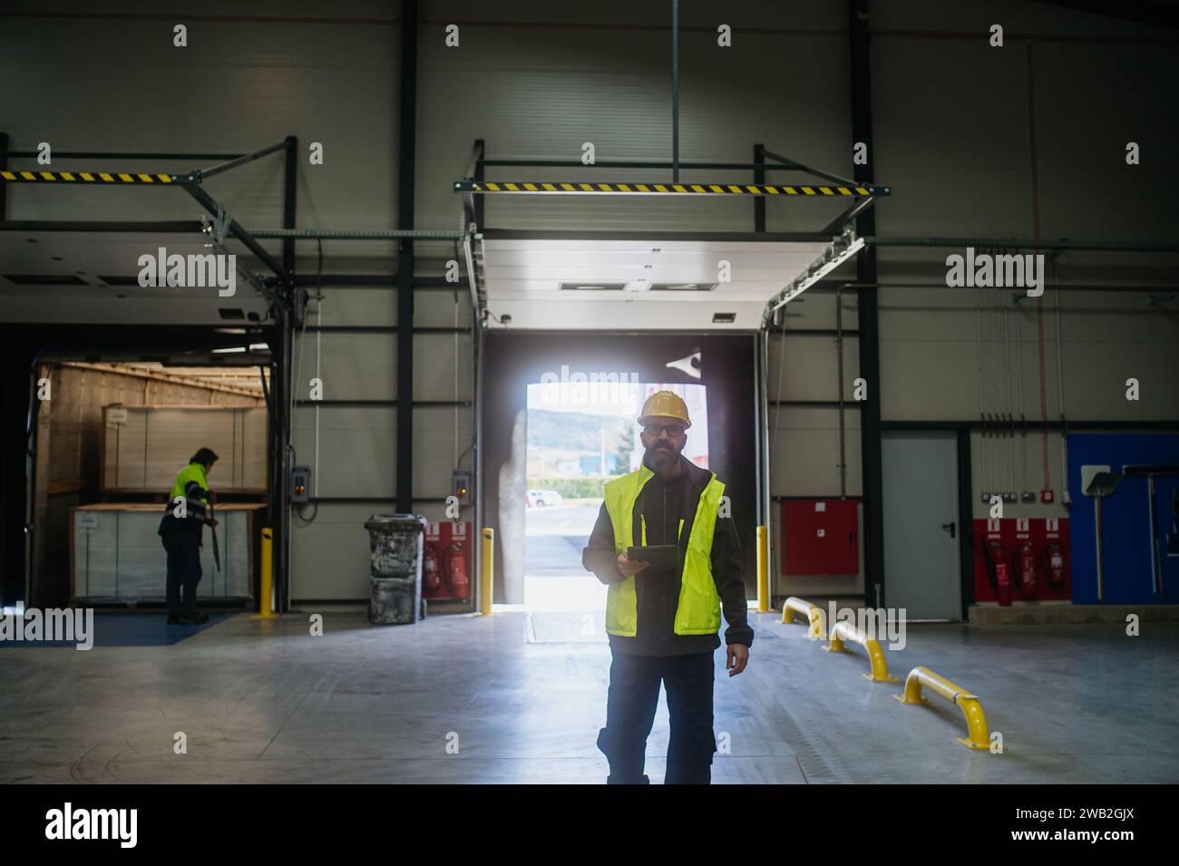 Warehouse receiver overseeing the storing of delivered items, holding ...