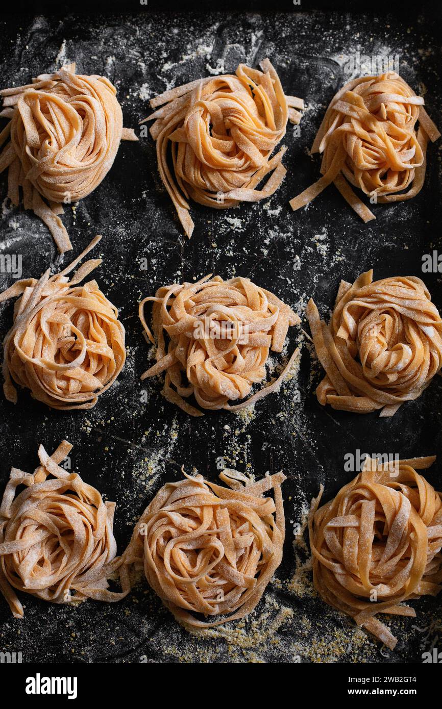 Fresh linguine pasta twirled on sheet pan Stock Photo - Alamy