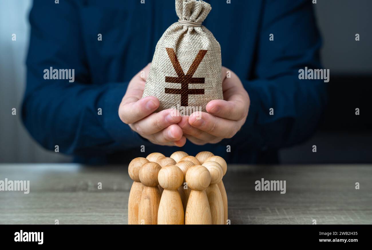 A man is holding a chinese yuan or japanese yen money bag over a group ...