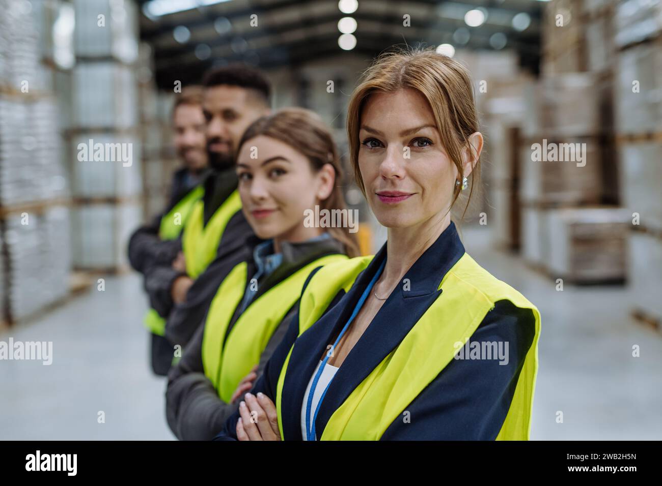 Full team of warehouse employees standing in warehouse. Team of workers ...