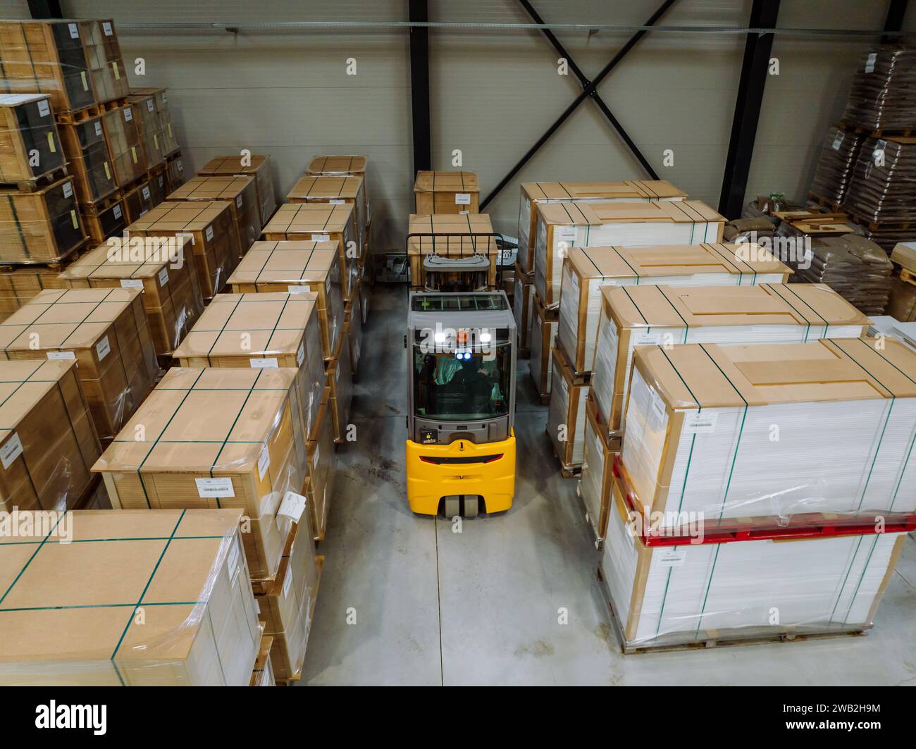 Top view of forklift in warehouse in the middle of stored goods ...