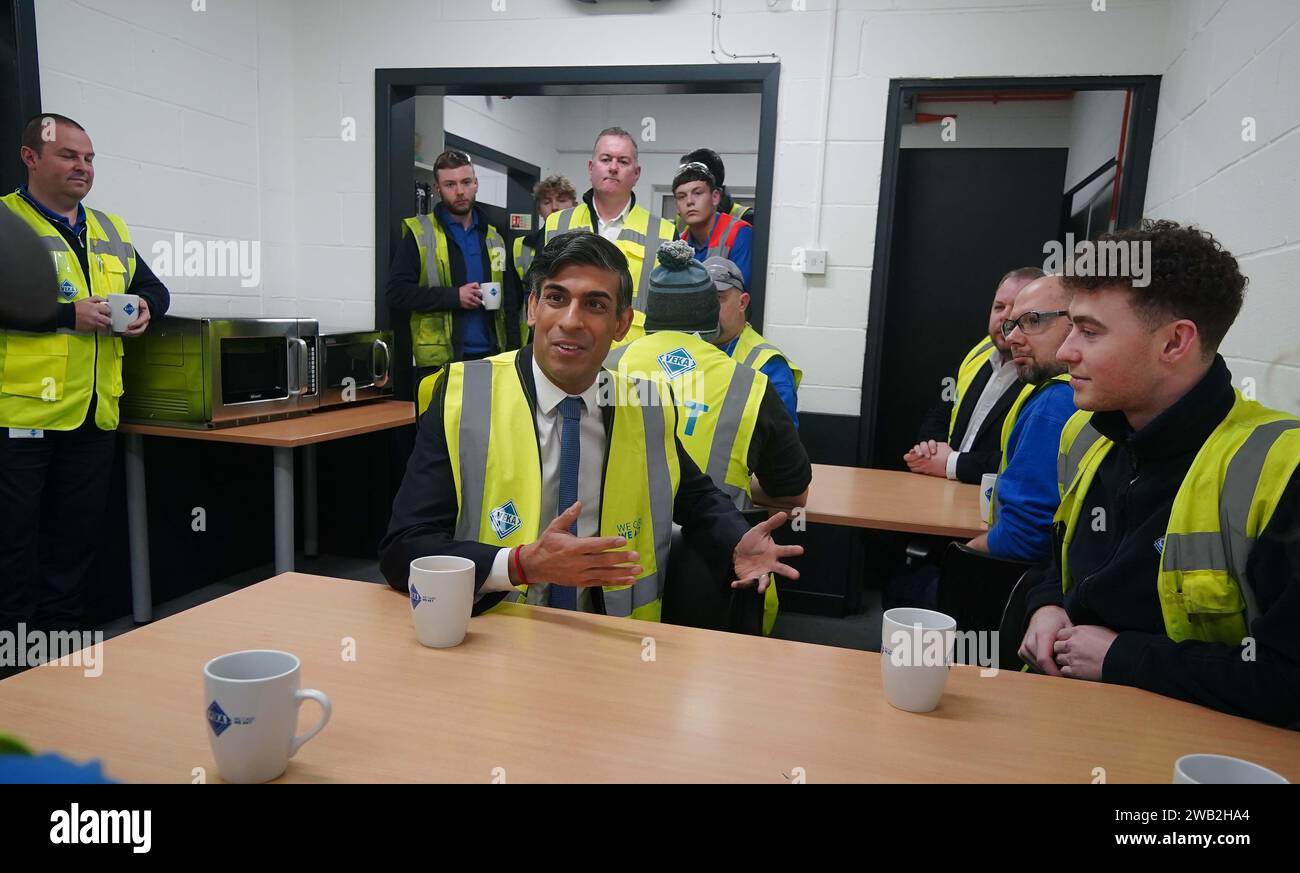 Prime Minister Rishi Sunak (centre) speaking to staff during a visit to ...