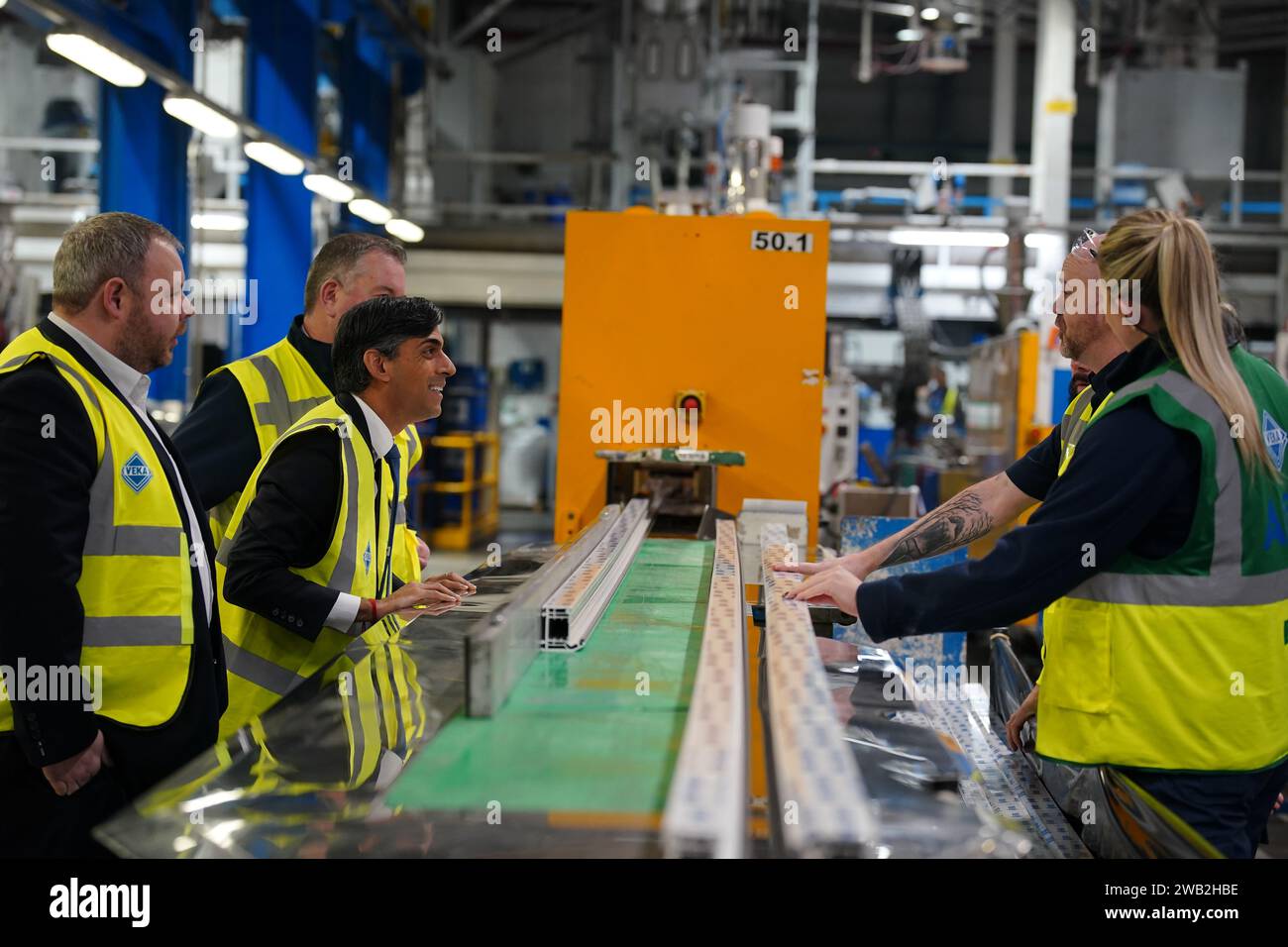 Prime Minister Rishi Sunak (3rd left) speaking to staff during a visit ...