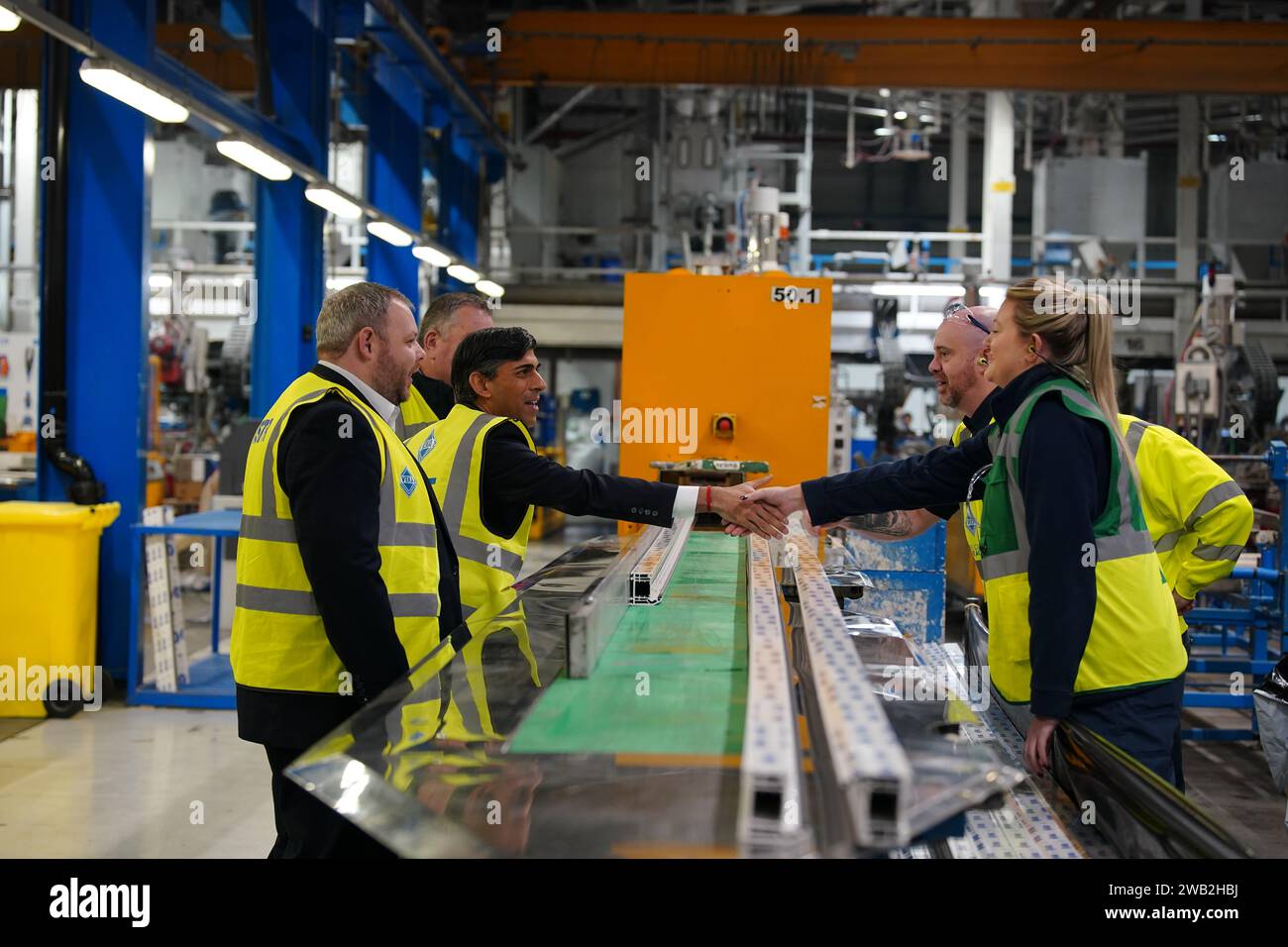 Prime Minister Rishi Sunak (3rd left) meets staff during a visit to ...