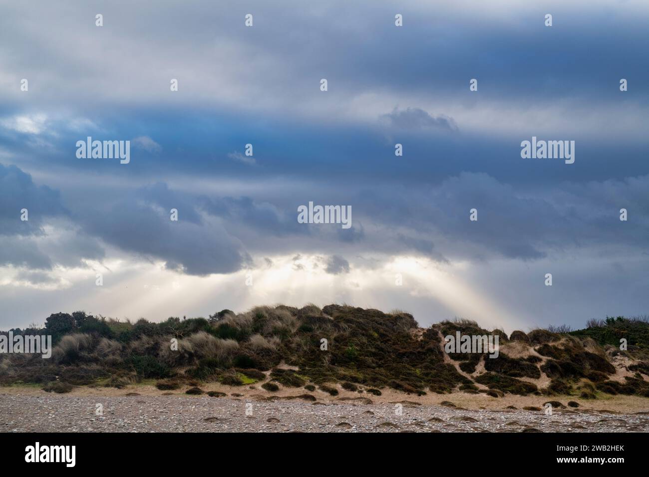 Rain clouds and sun rays over Findhorn beach sand dunes. Findhorn ...