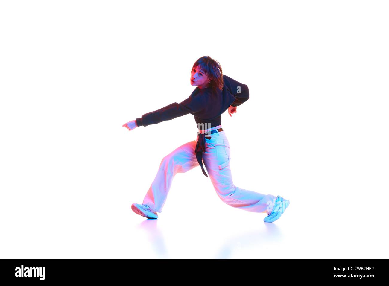 Young woman dancing hip hop, breakdance, dance hall isolated over white ...