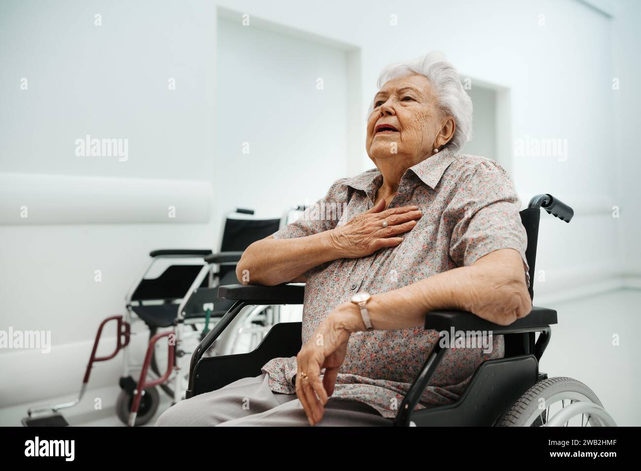 Senior woman with heart attack feeling chest pain. Elderly patient with ...