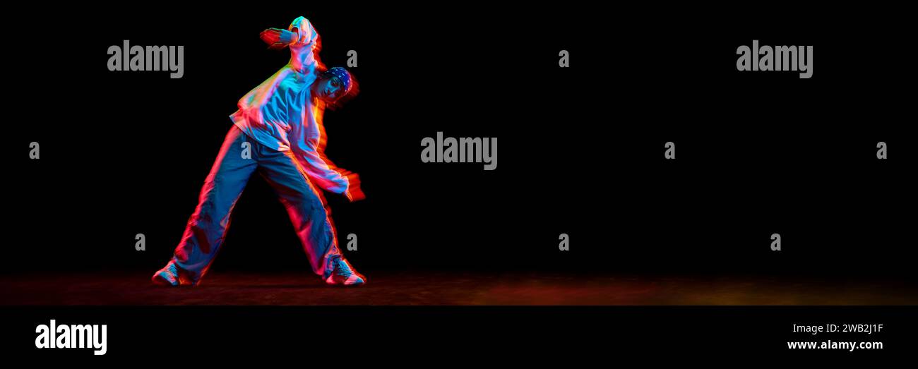 Young girl, hip hop dancer in motion, dancing isolated over black ...