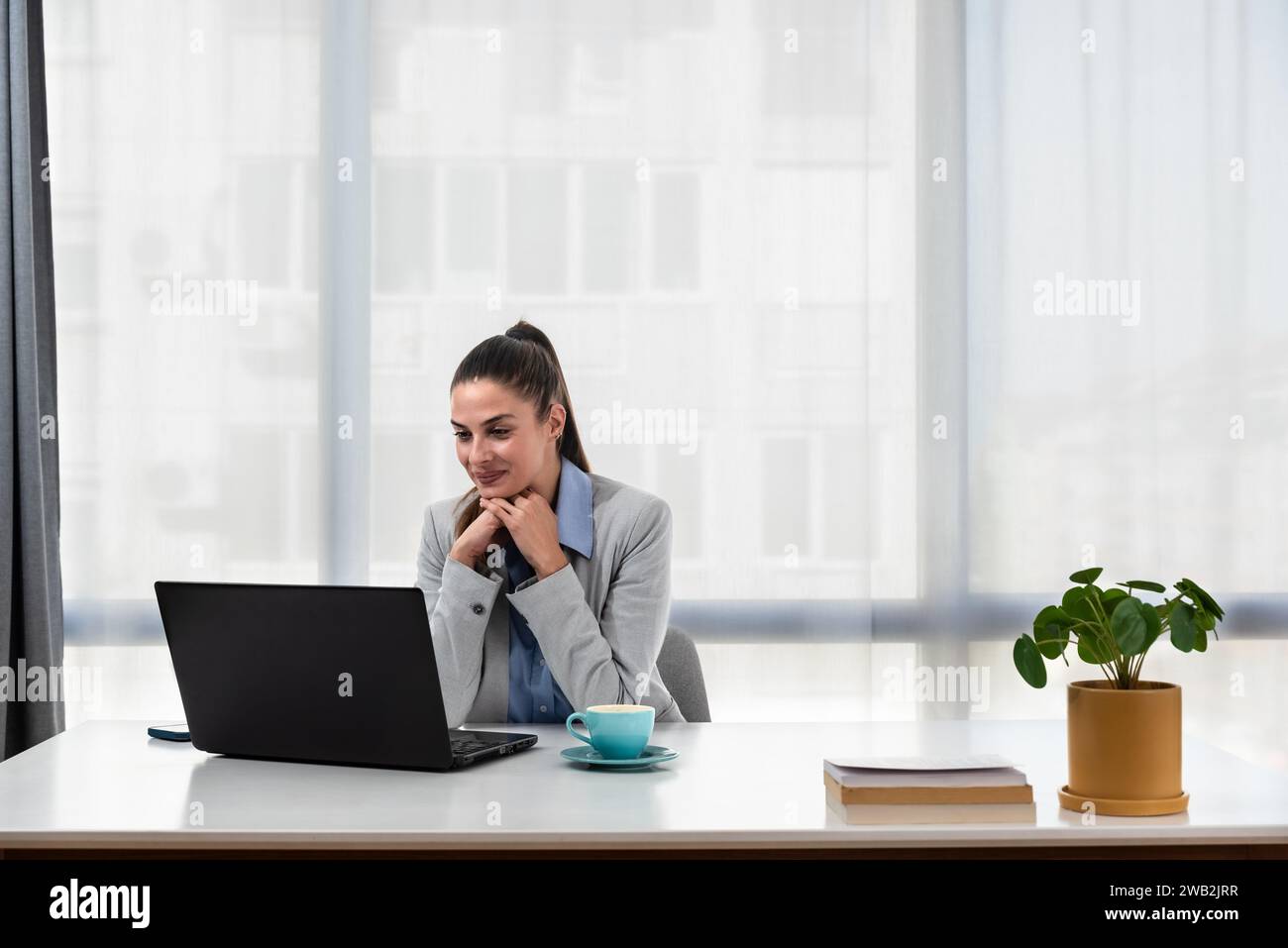 Young businesswoman adjusting to her new workplace after being promoted ...